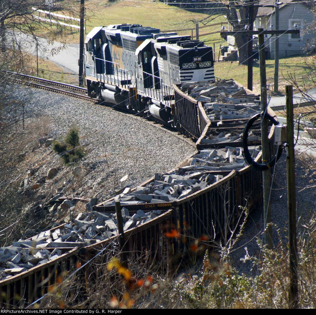 FURX 5503 trails B01220 loaded with scrap concrete ties.